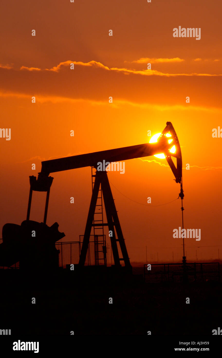 Oil Pumping Unit At Sunset Stock Photo - Alamy