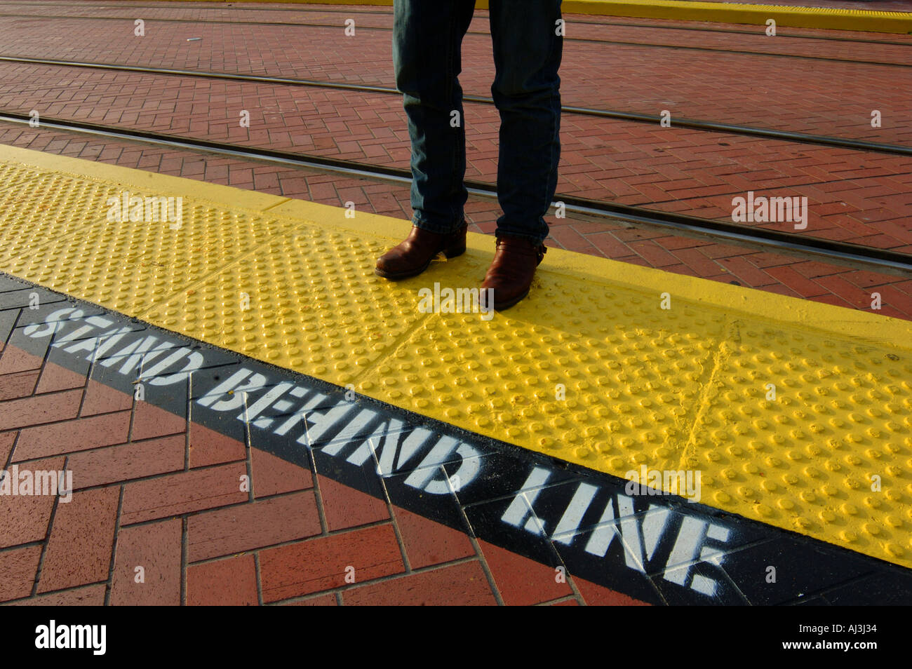 Standing behind the yellow line hi-res stock photography and images - Alamy