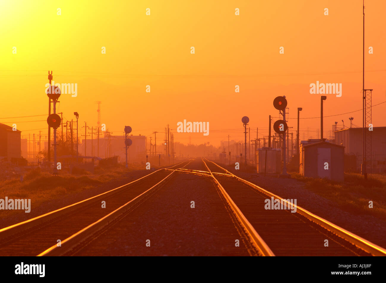 Railroad Tracks Crossing Signals At Sunset Sunrise Stock Photo - Alamy