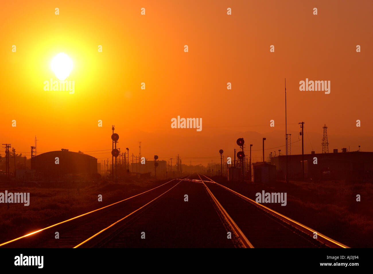 Railroad Tracks Crossing Signals At Sunset Sunrise Stock Photo - Alamy