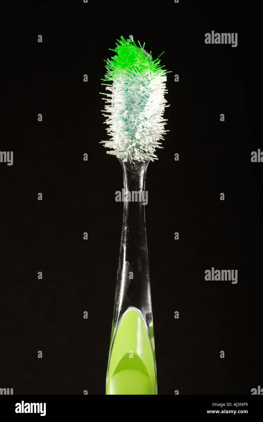 Worn toothbrush upright standing Stock Photo - Alamy