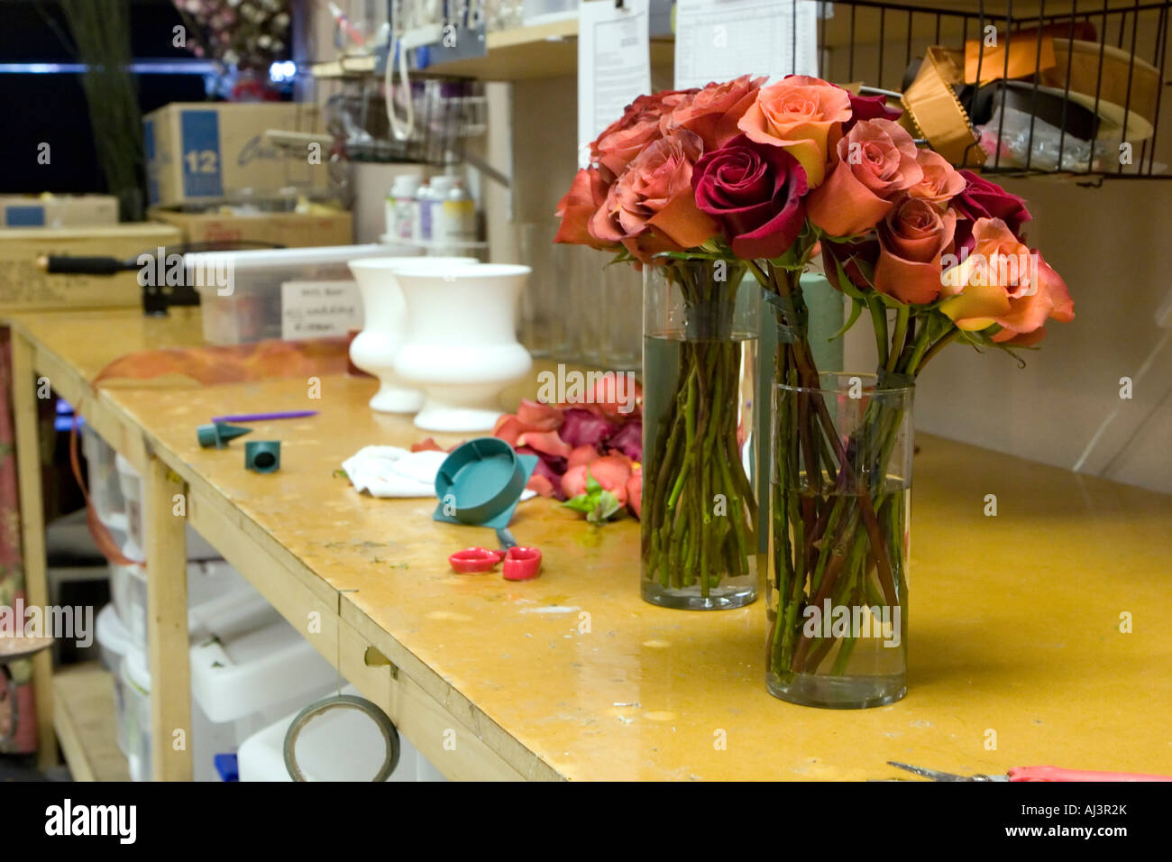 Florist works on creating a rose bouquet in workroom Stock Photo - Alamy