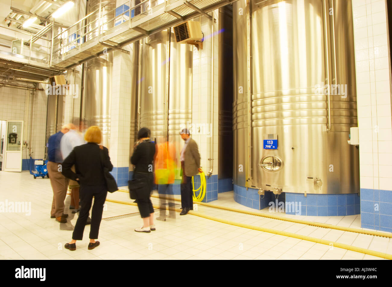 In the winery: A group of visitors in the main blending hall with big ...