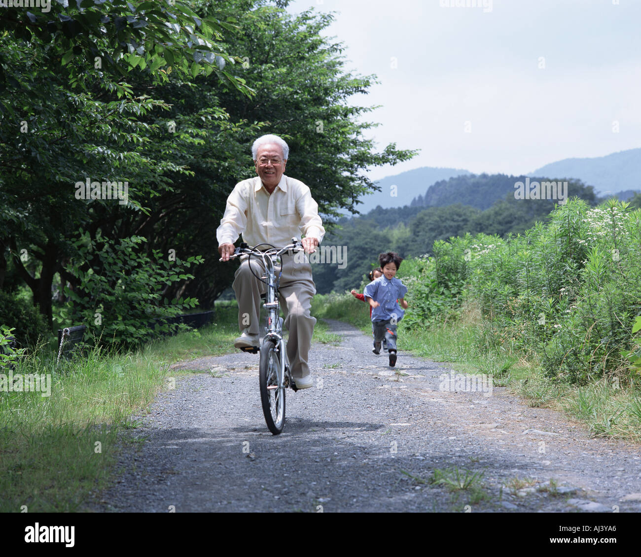 A grand father riding a bicycle Stock Photo - Alamy
