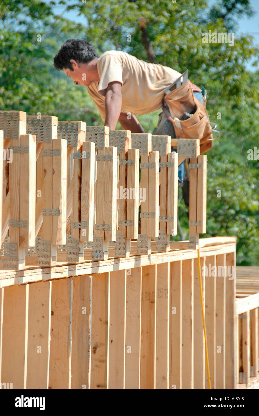 Latin American Mexican work crew building wooden stick built house home ...