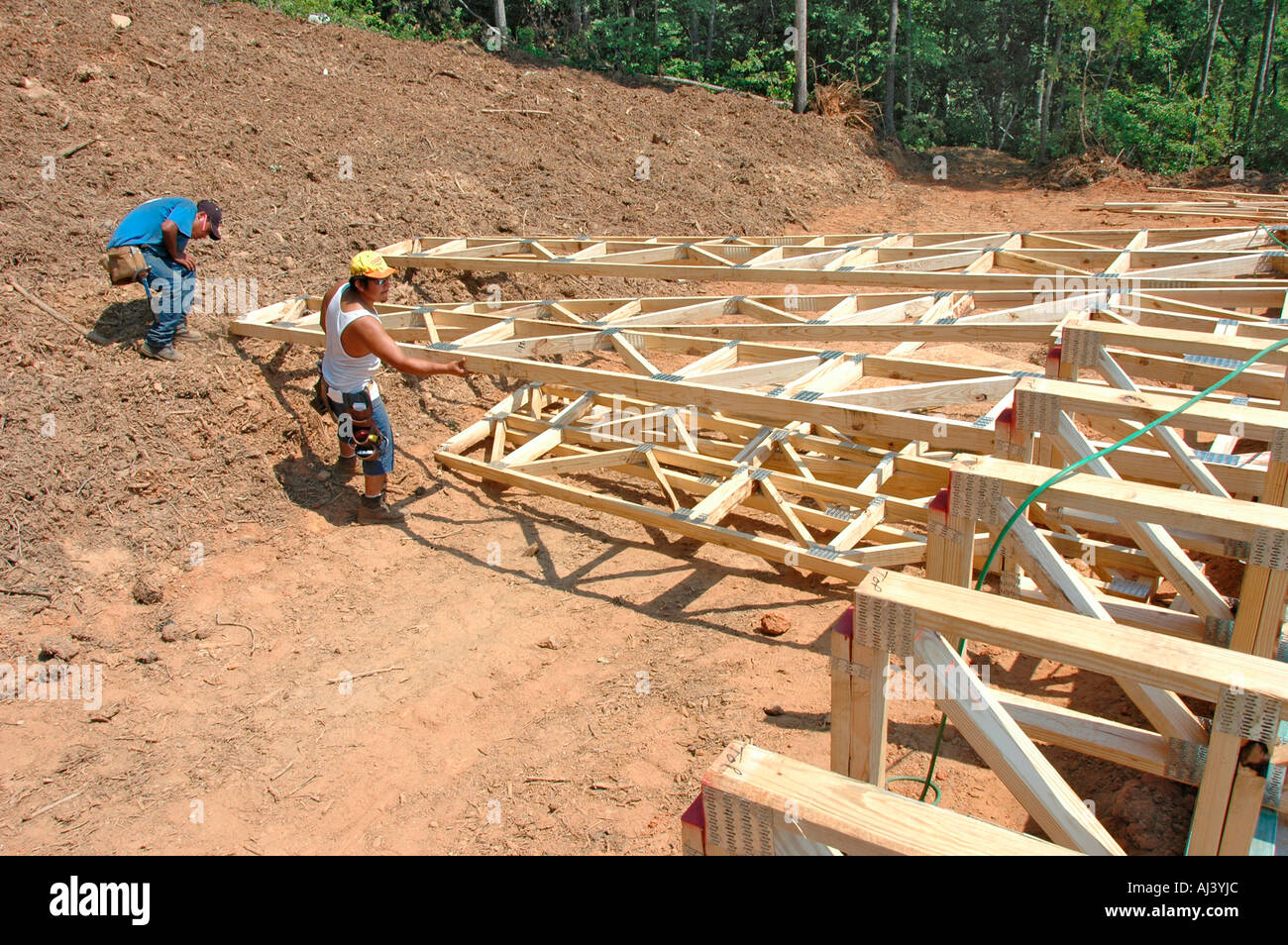 Latin American Mexican work crew building wooden stick built house home ...