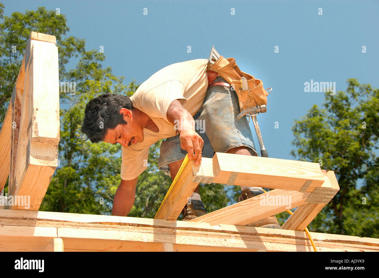 Latin American Mexican work crew building wooden stick built house home ...
