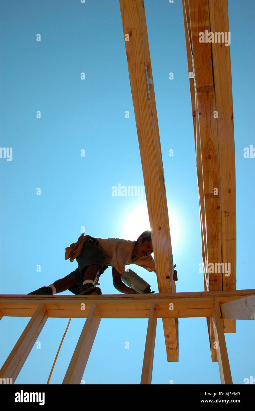 Latin American Mexican work crew building wooden stick built house home ...