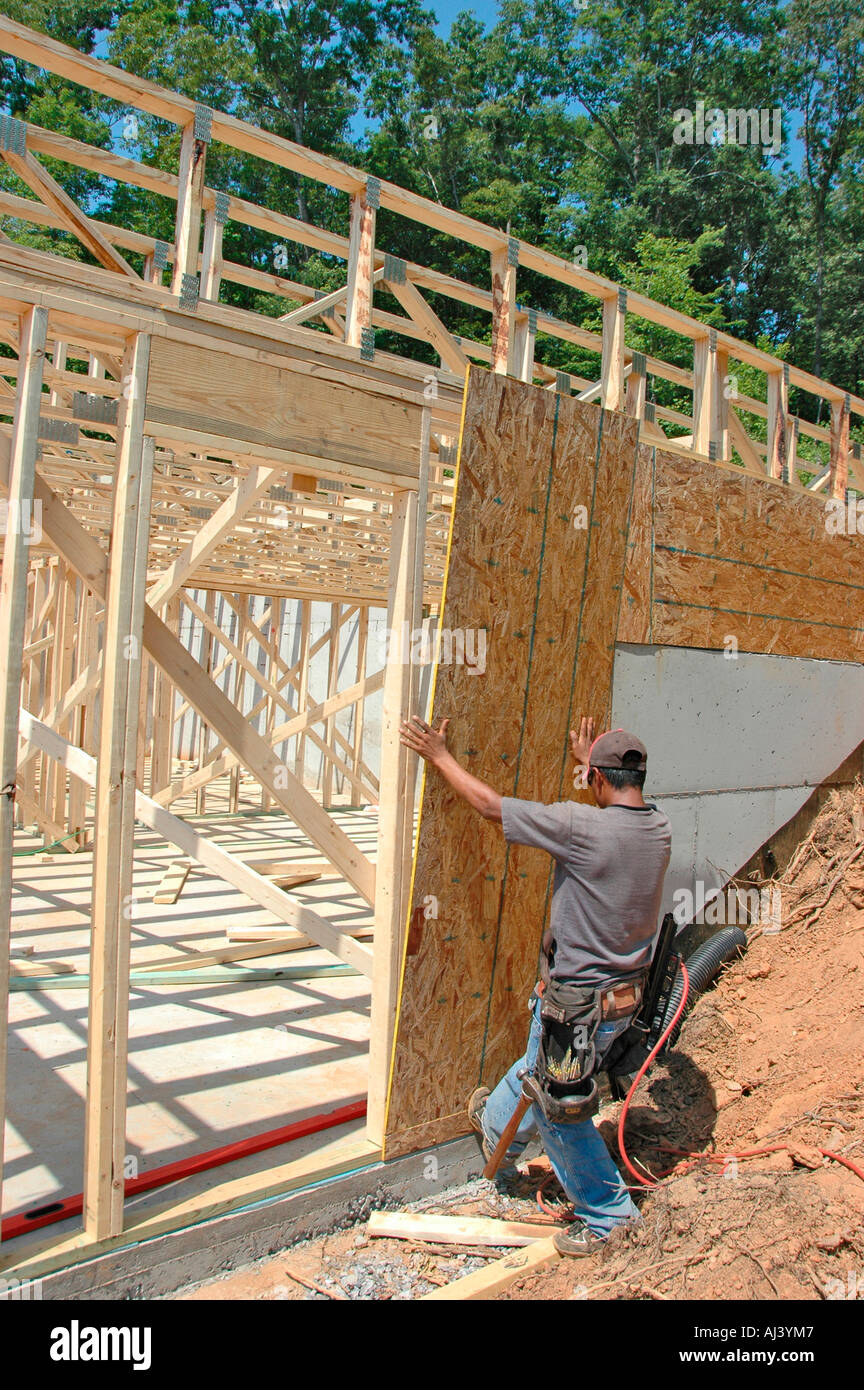 Latin American Mexican work crew building wooden stick built house home ...