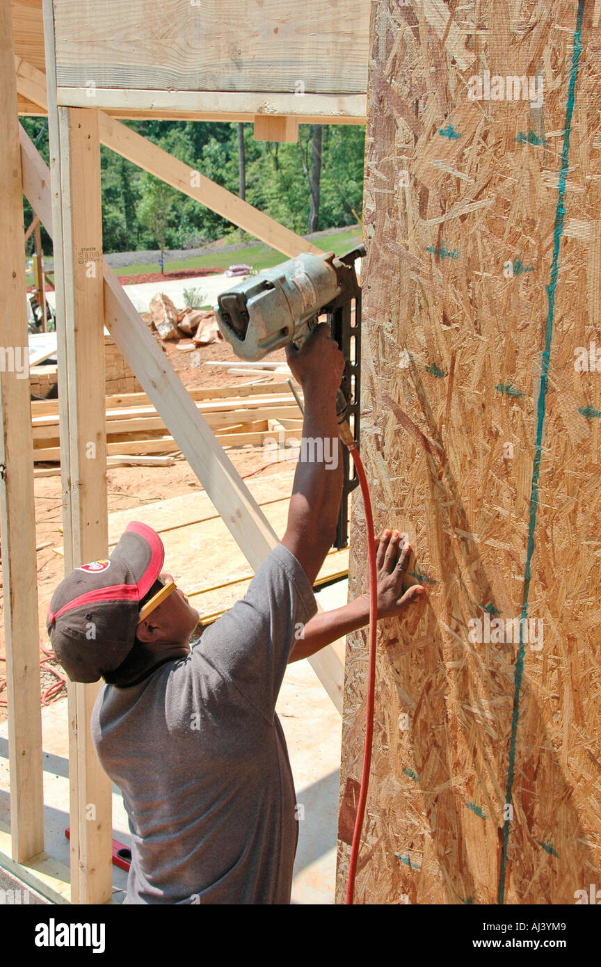 Latin American Mexican work crew building wooden stick built house home ...