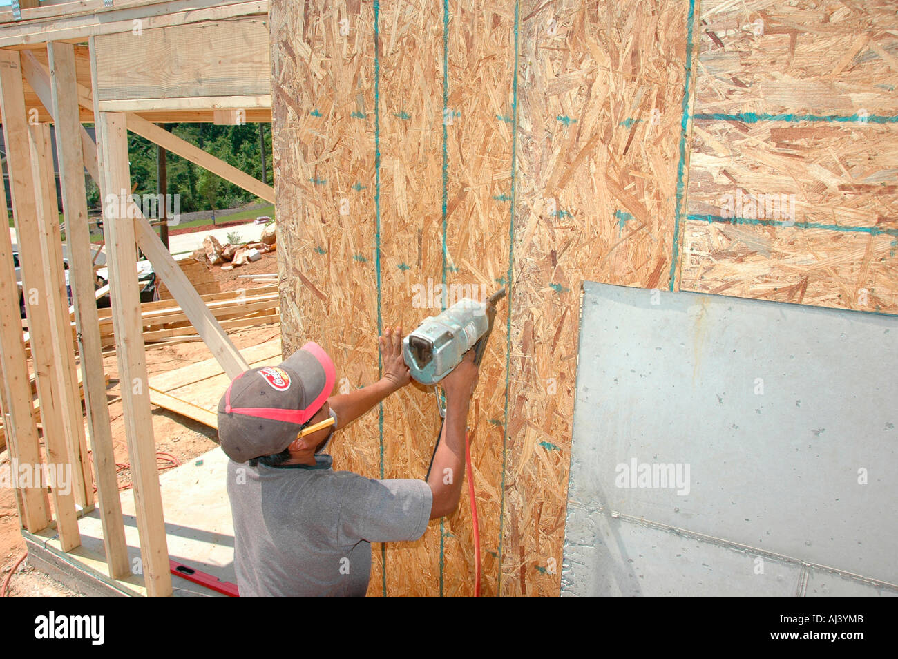 Latin American Mexican work crew building wooden stick built house home ...