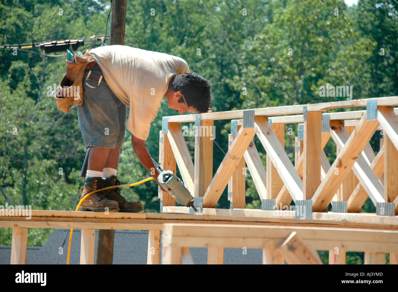 Latin American Mexican work crew building wooden stick built house home ...