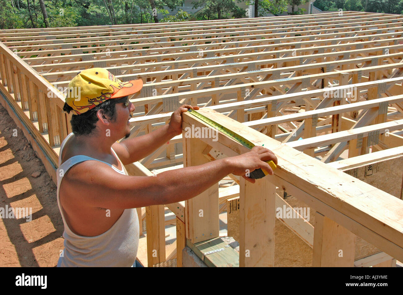 Latin American Mexican work crew building wooden stick built house home ...