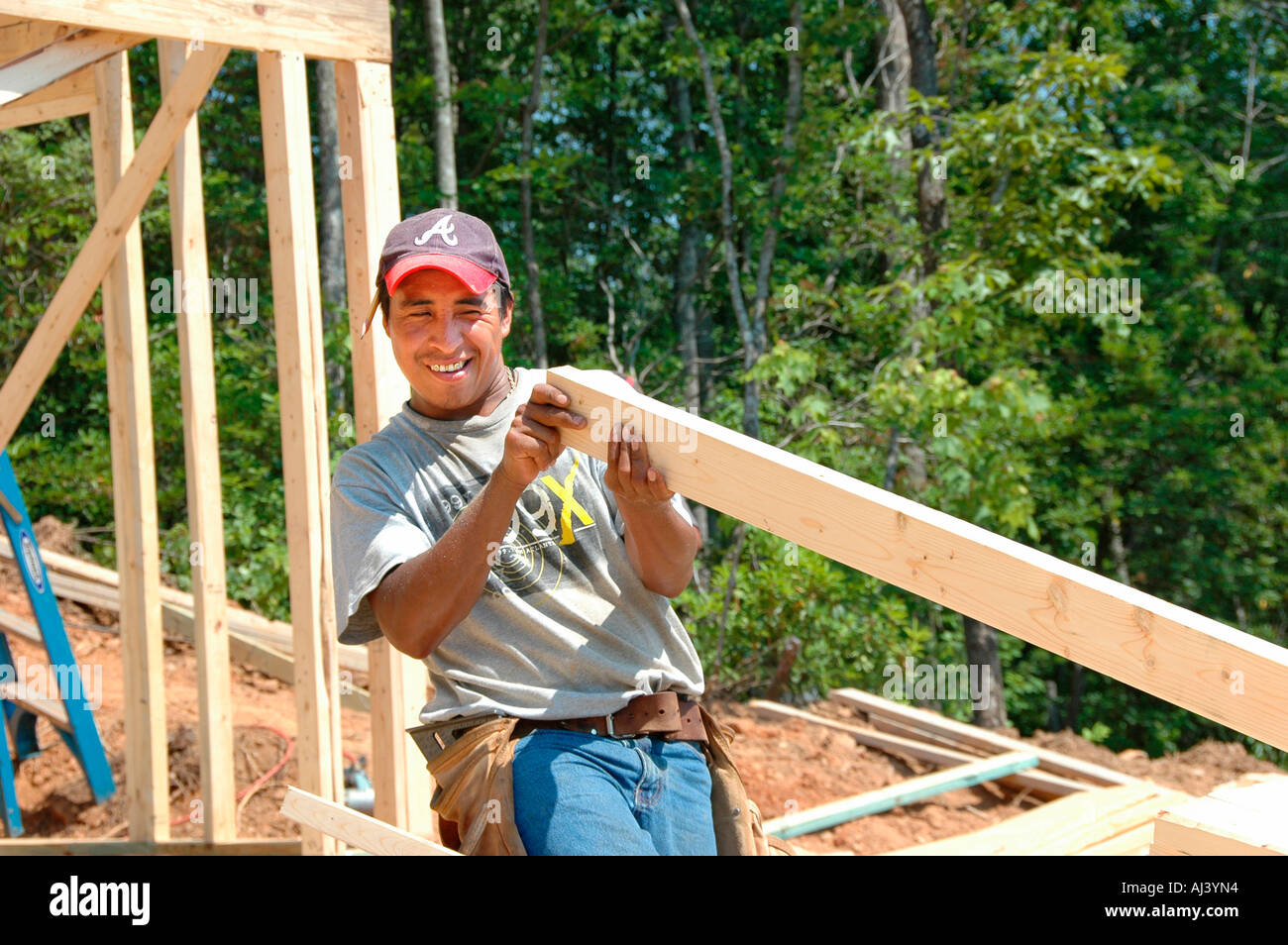 Latin American Mexican work crew building wooden stick built house home ...
