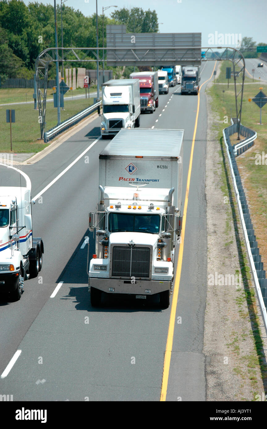 Commercial Trucks in highways roads freeways with cars moving to the ...