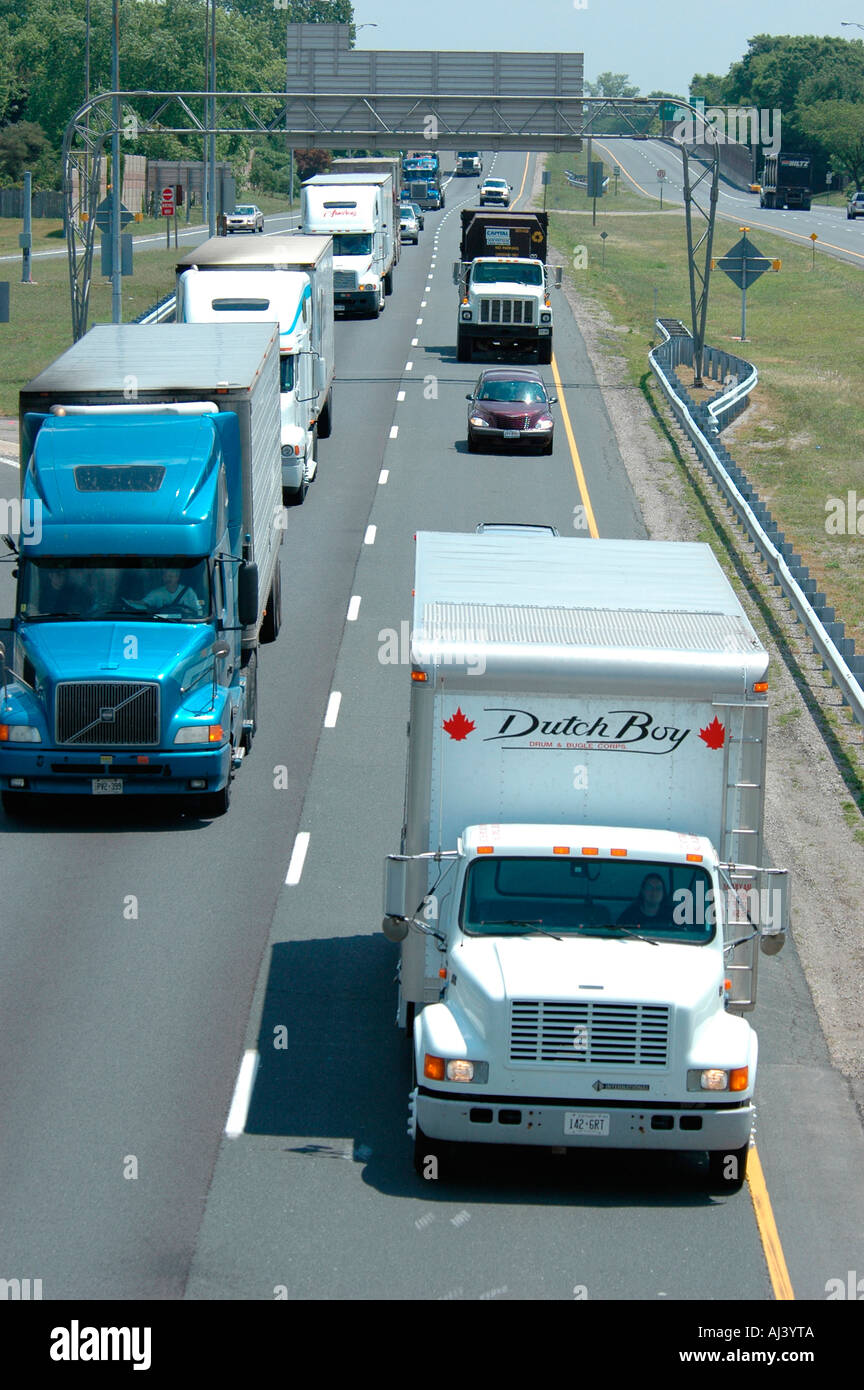 Commercial Trucks in highways roads freeways with cars moving to the ...