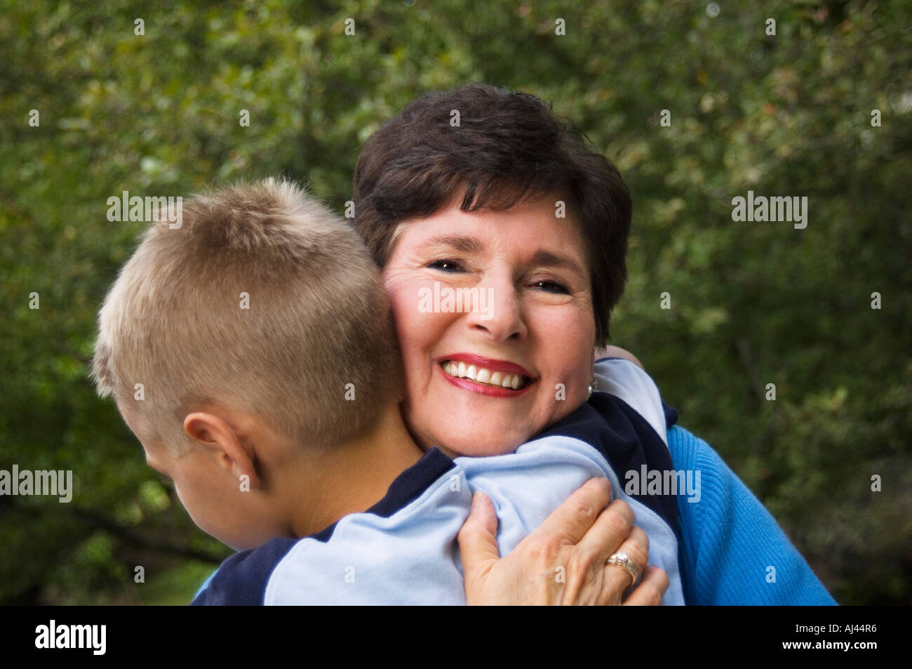 Grandson hugging grandma Stock Photo - Alamy