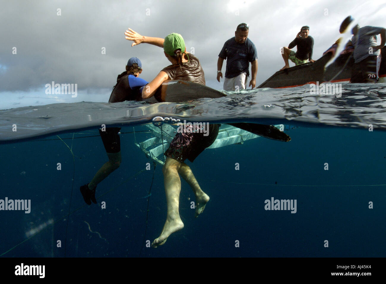 Sailors wait for rescue on capsized Marshalhese outrigger canoe Ailuk ...