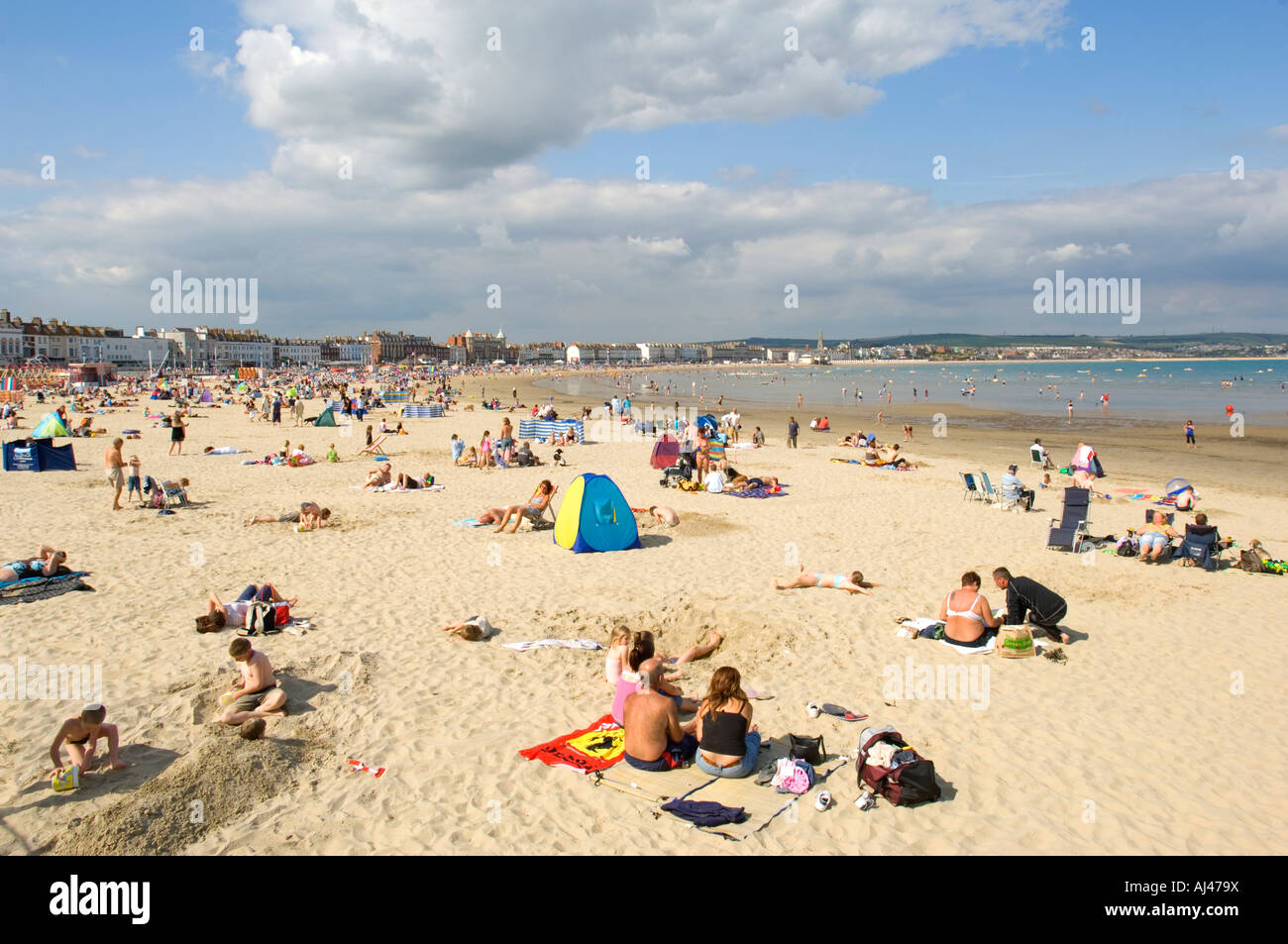 A wide angle view of a typical English beach scene on the sandy bay at ...