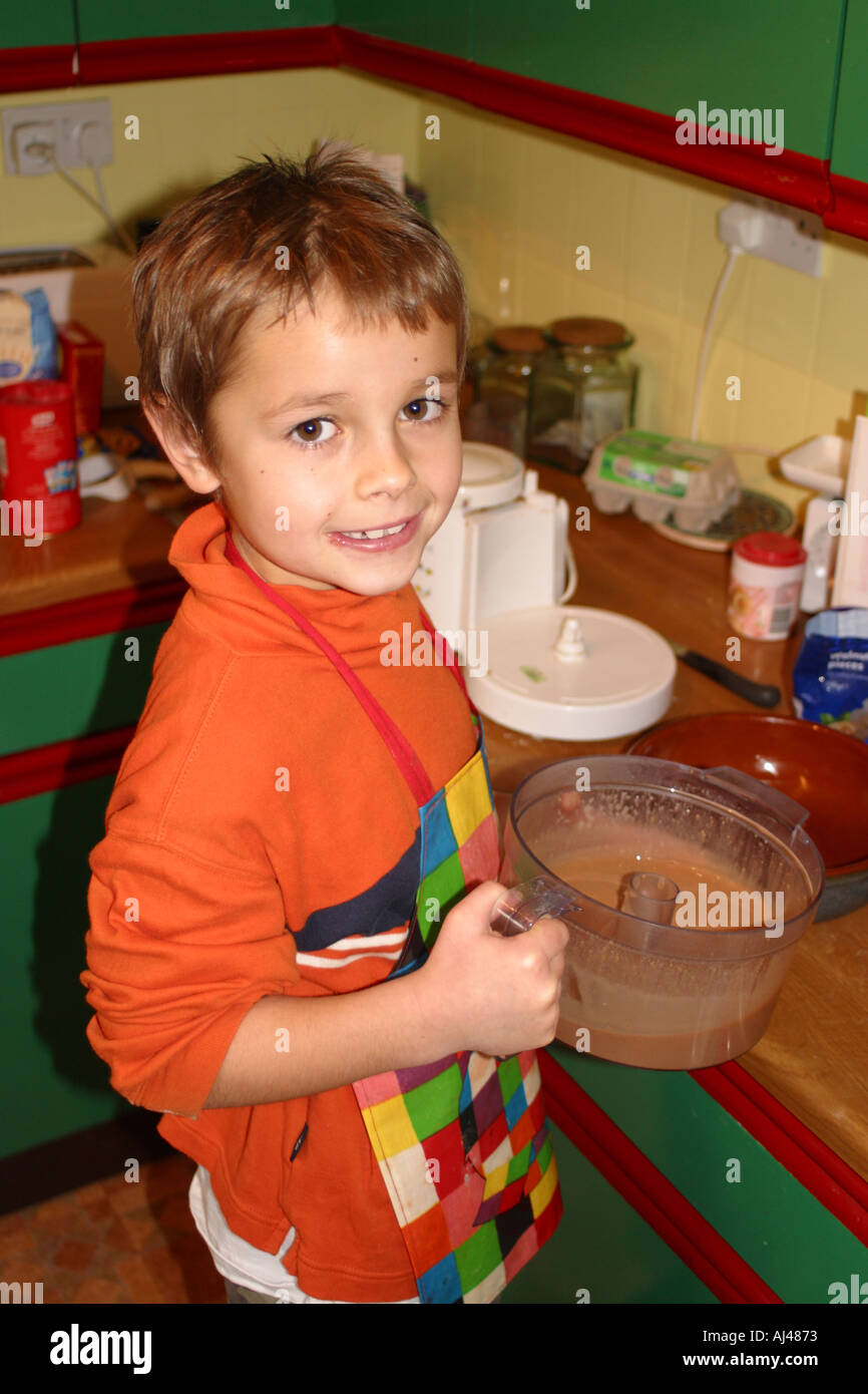 Young boy making a chocolate cake in the family kitchen Stock Photo - Alamy