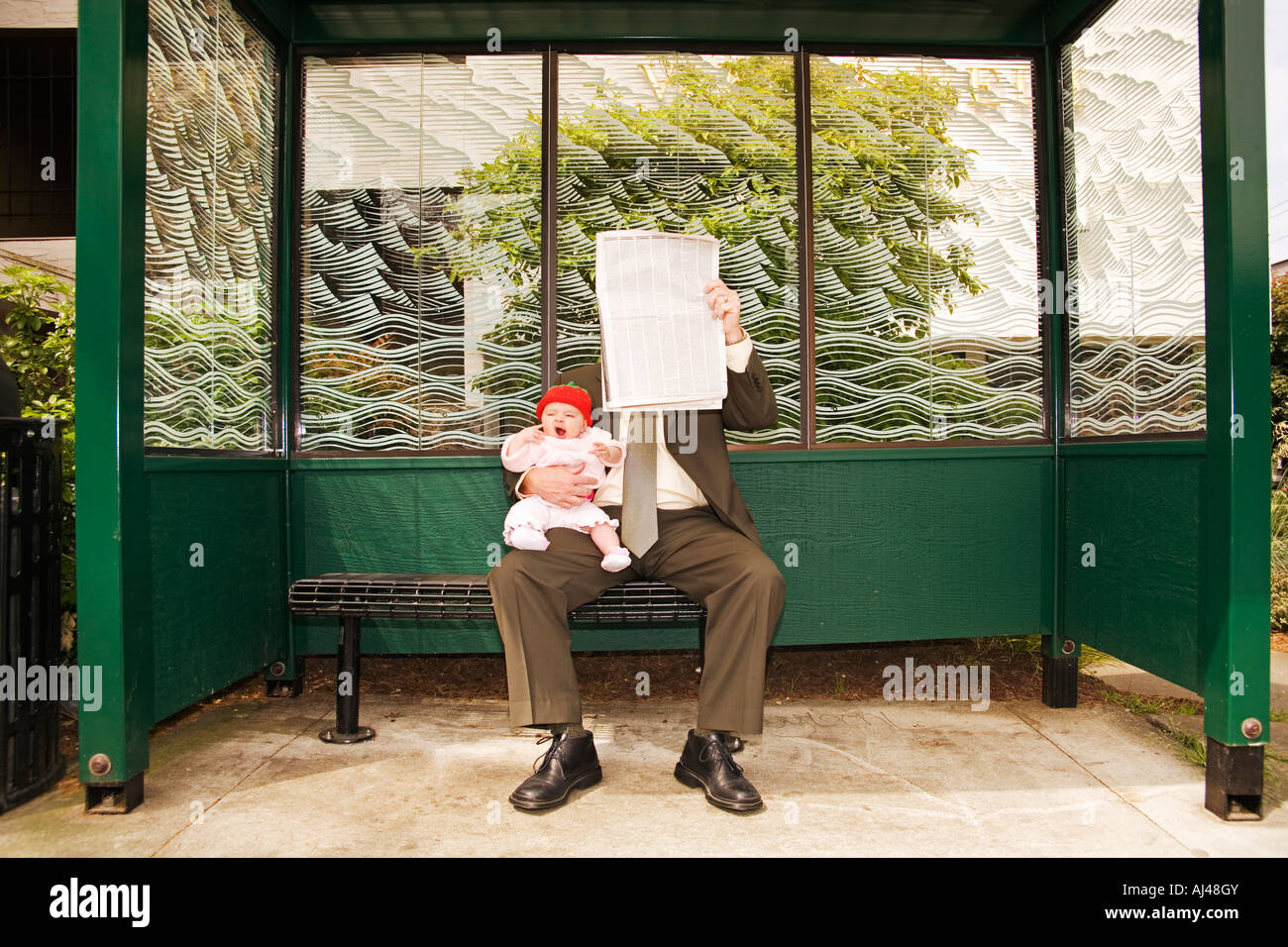 Reading newspaper bus stop hi-res stock photography and images - Alamy