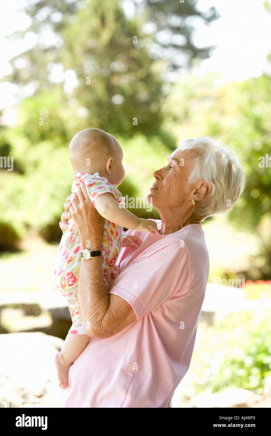Old woman holding baby hi-res stock photography and images - Alamy