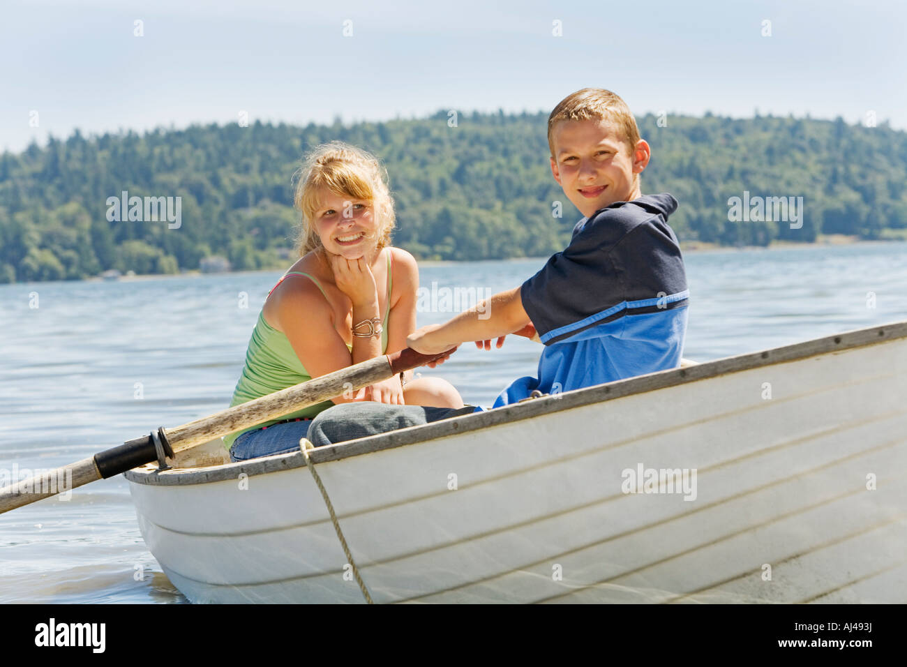 Boy and girl in row boat Stock Photo - Alamy