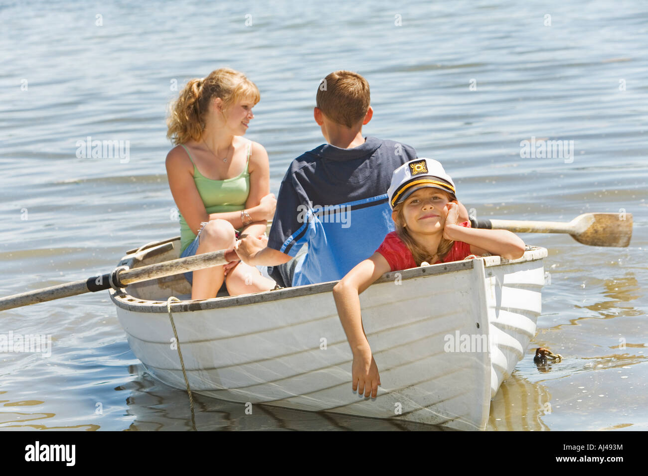 Boy and girl in row boat with young sibling Stock Photo - Alamy