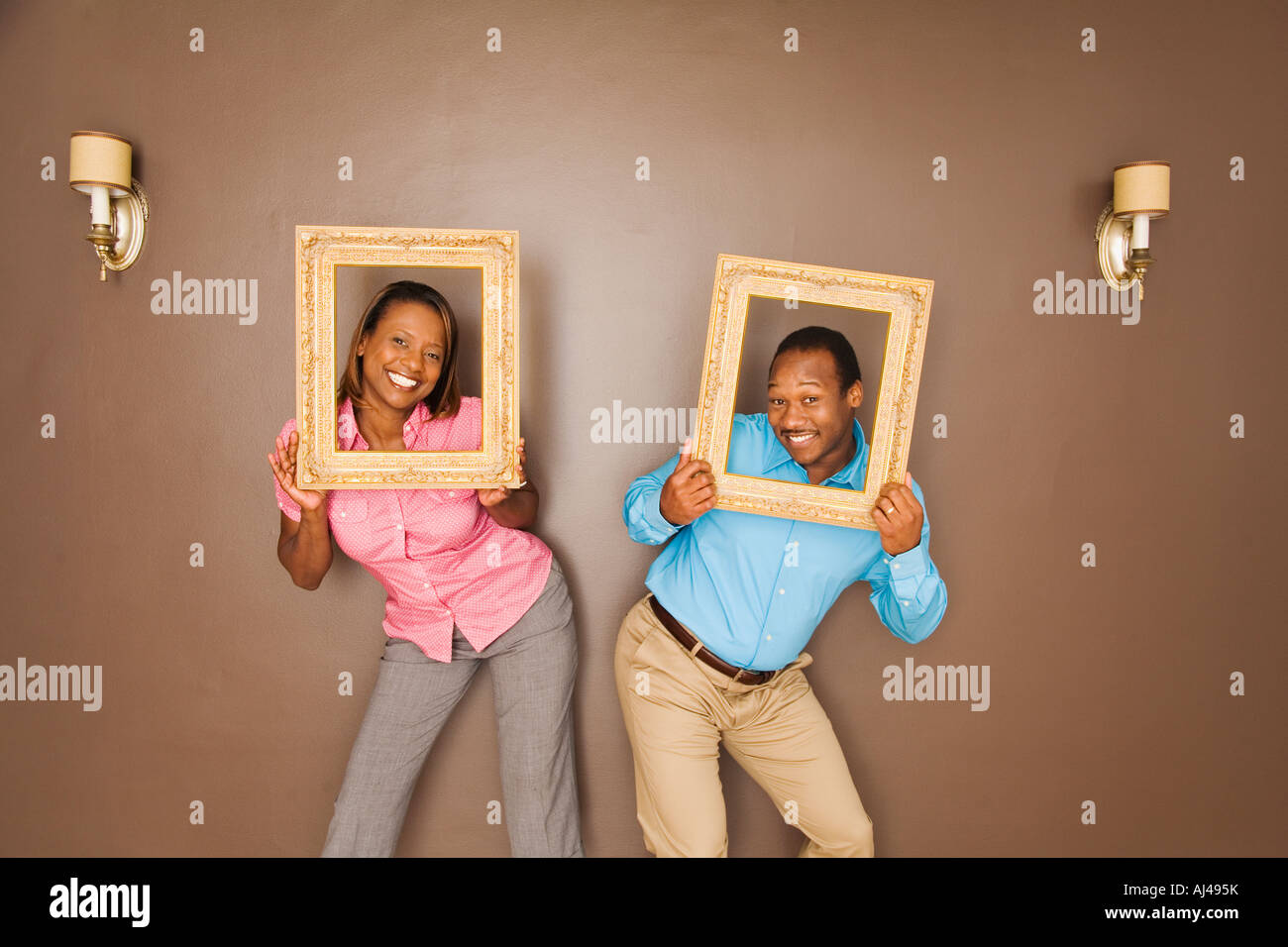 African couple looking through picture frames Stock Photo - Alamy