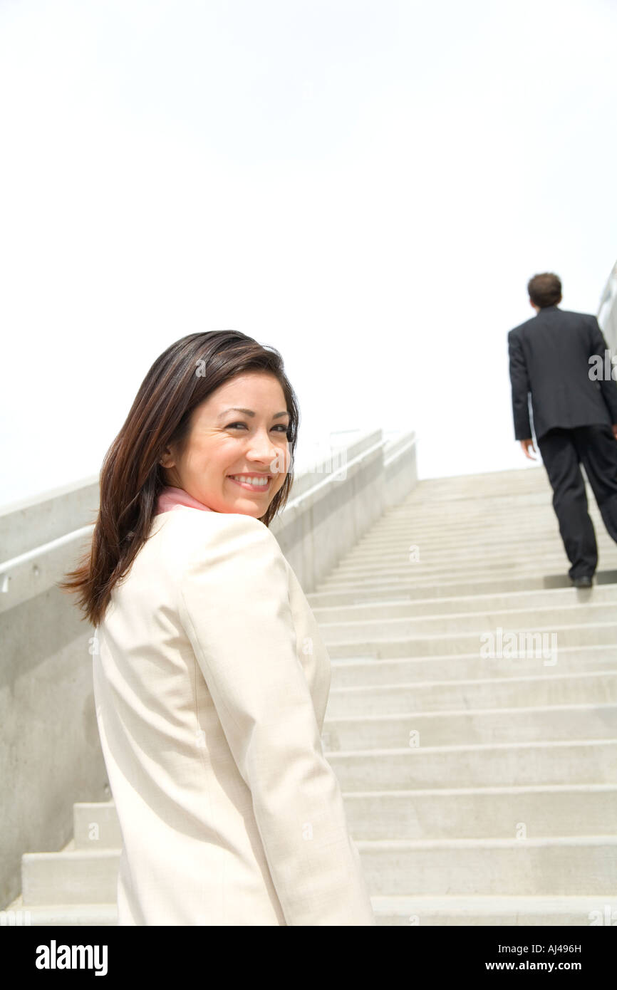 Businesswoman looking over shoulder Stock Photo - Alamy