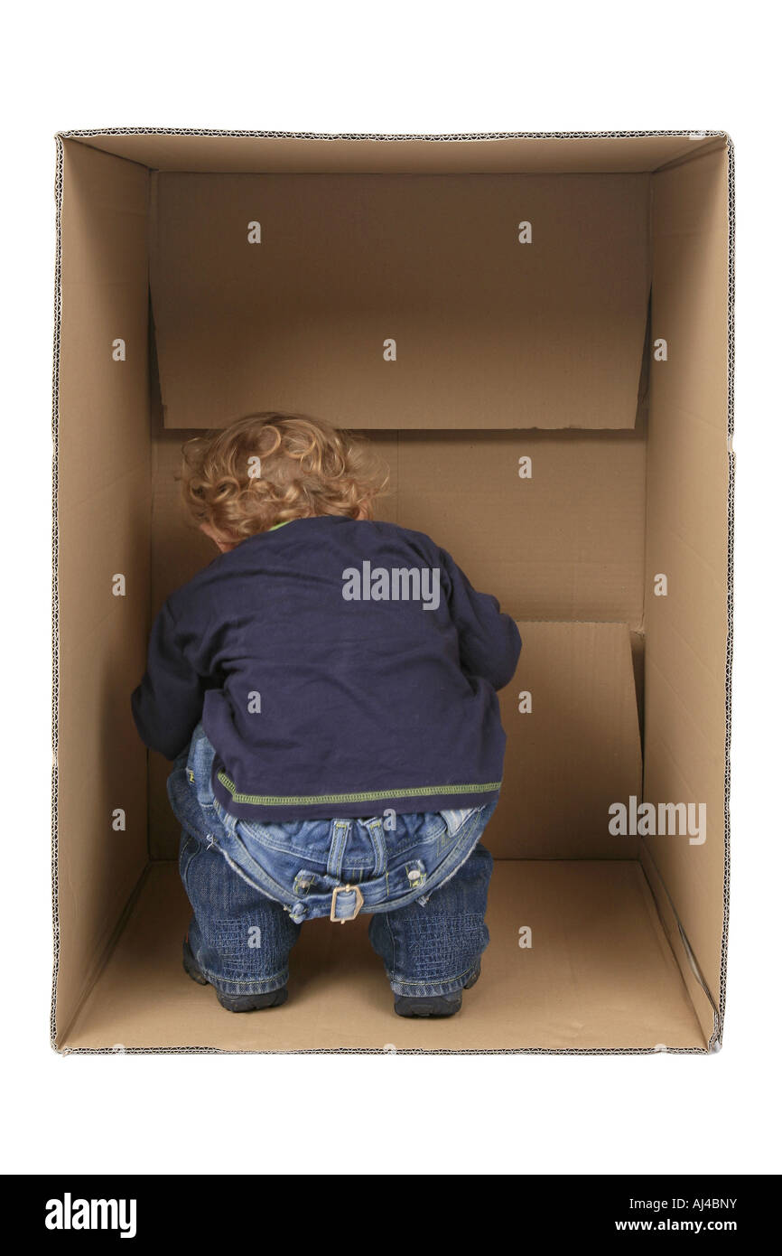 little child inspecting box Stock Photo - Alamy