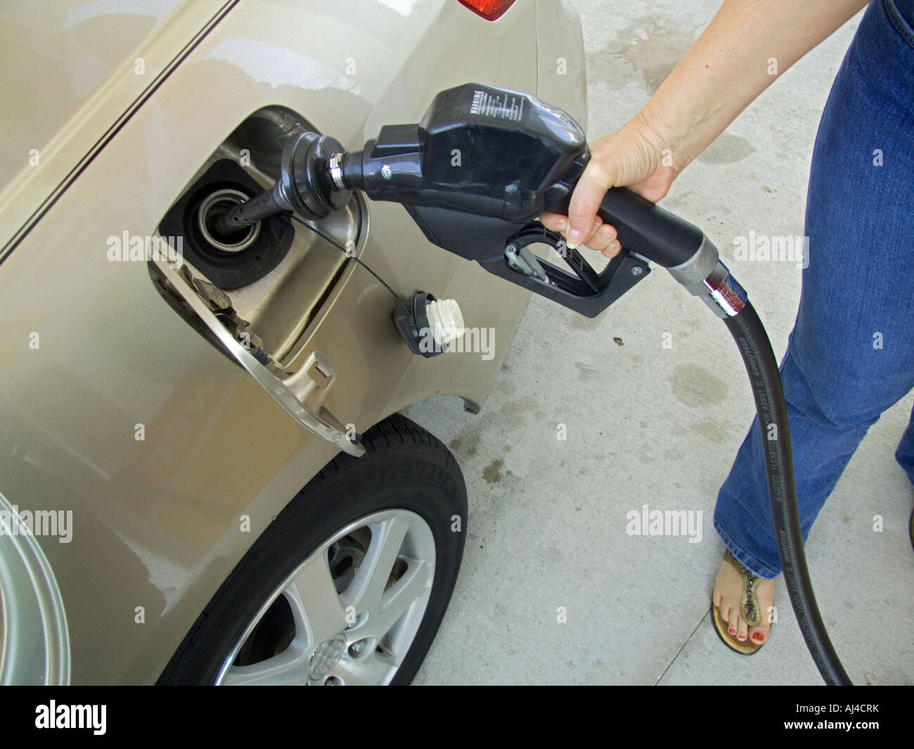 Woman pumping gas fueling car hi-res stock photography and images - Alamy