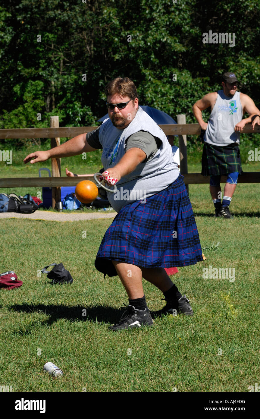 Contestant at a Highland Games gathering throwing the weight for ...