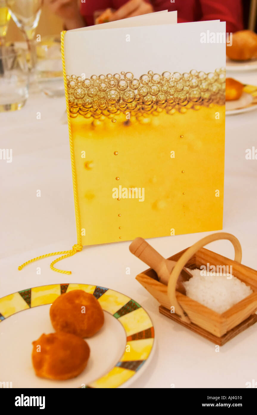 A menu standing on a table for a champagne lunch and tasting with a ...