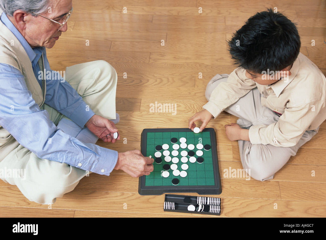 A boy playing game with grand father Stock Photo - Alamy