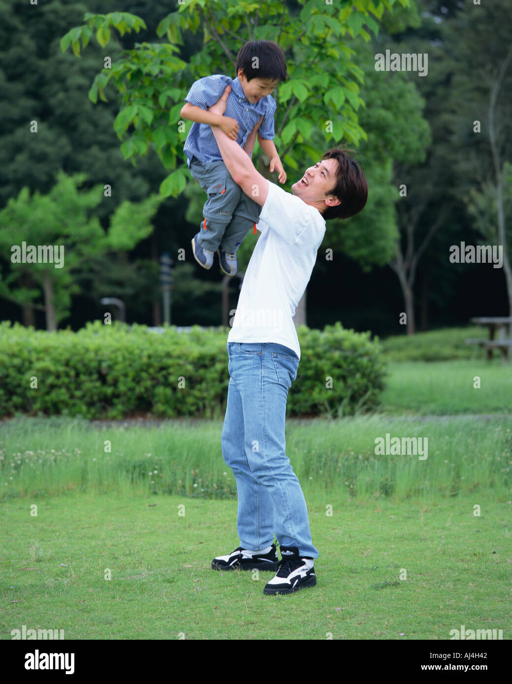 Father lifting up son Stock Photo - Alamy
