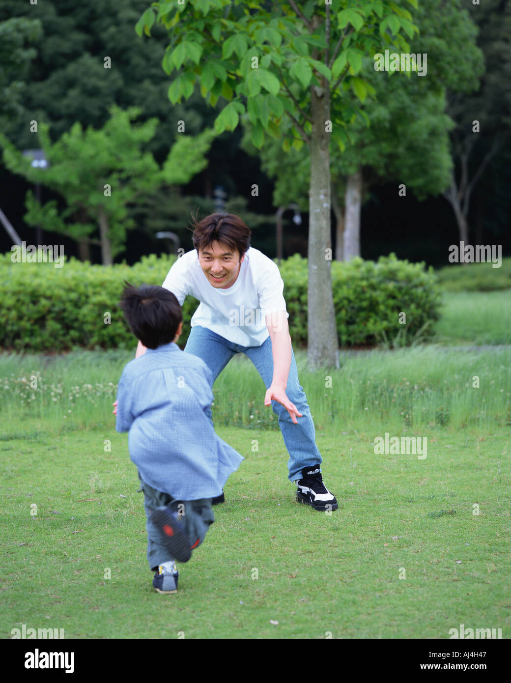 A boy running up to his father Stock Photo - Alamy