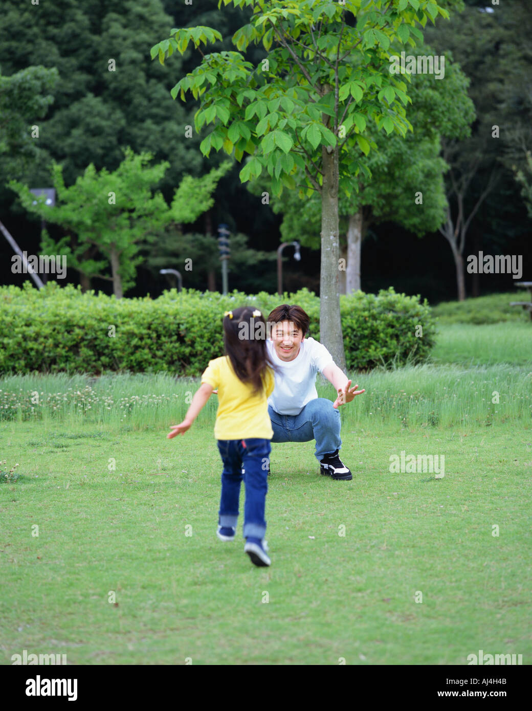 A girl running up to his father Stock Photo - Alamy