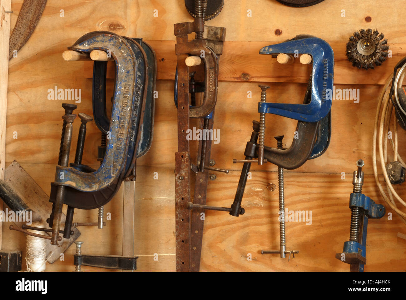 Wood workshop g clamps metal clamps Stock Photo - Alamy