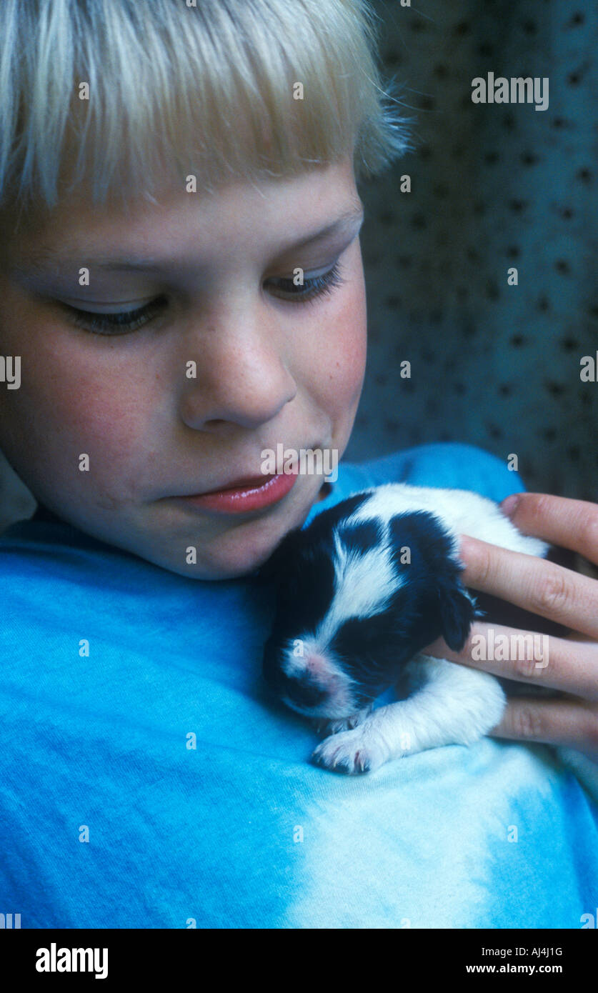 a young boy cuddling his puppy Stock Photo - Alamy