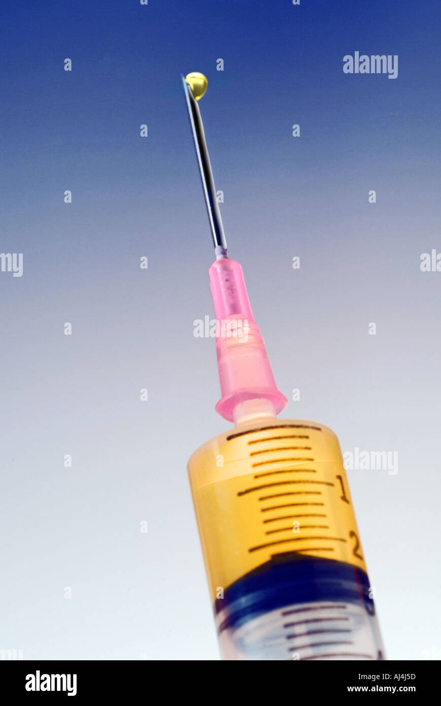 Syringe with liquid drop on needle Stock Photo - Alamy
