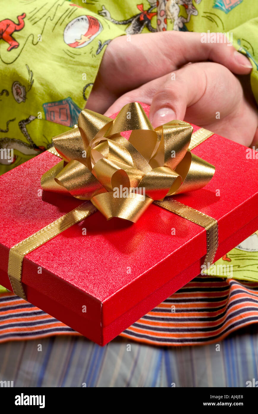 Boy hiding gift behind back Stock Photo - Alamy