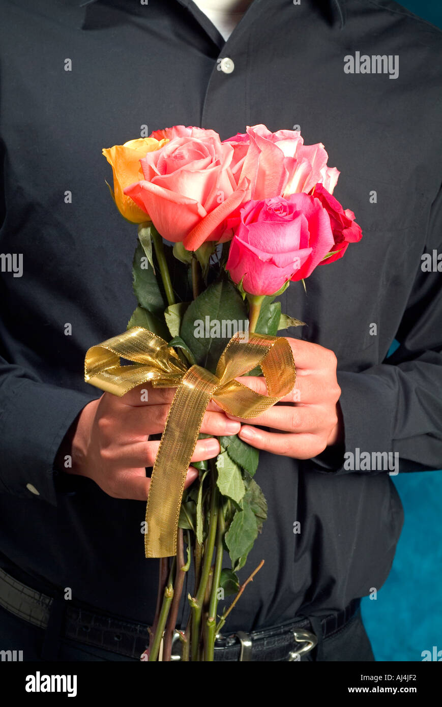 Man holding bouquet of multi colored roses Stock Photo - Alamy