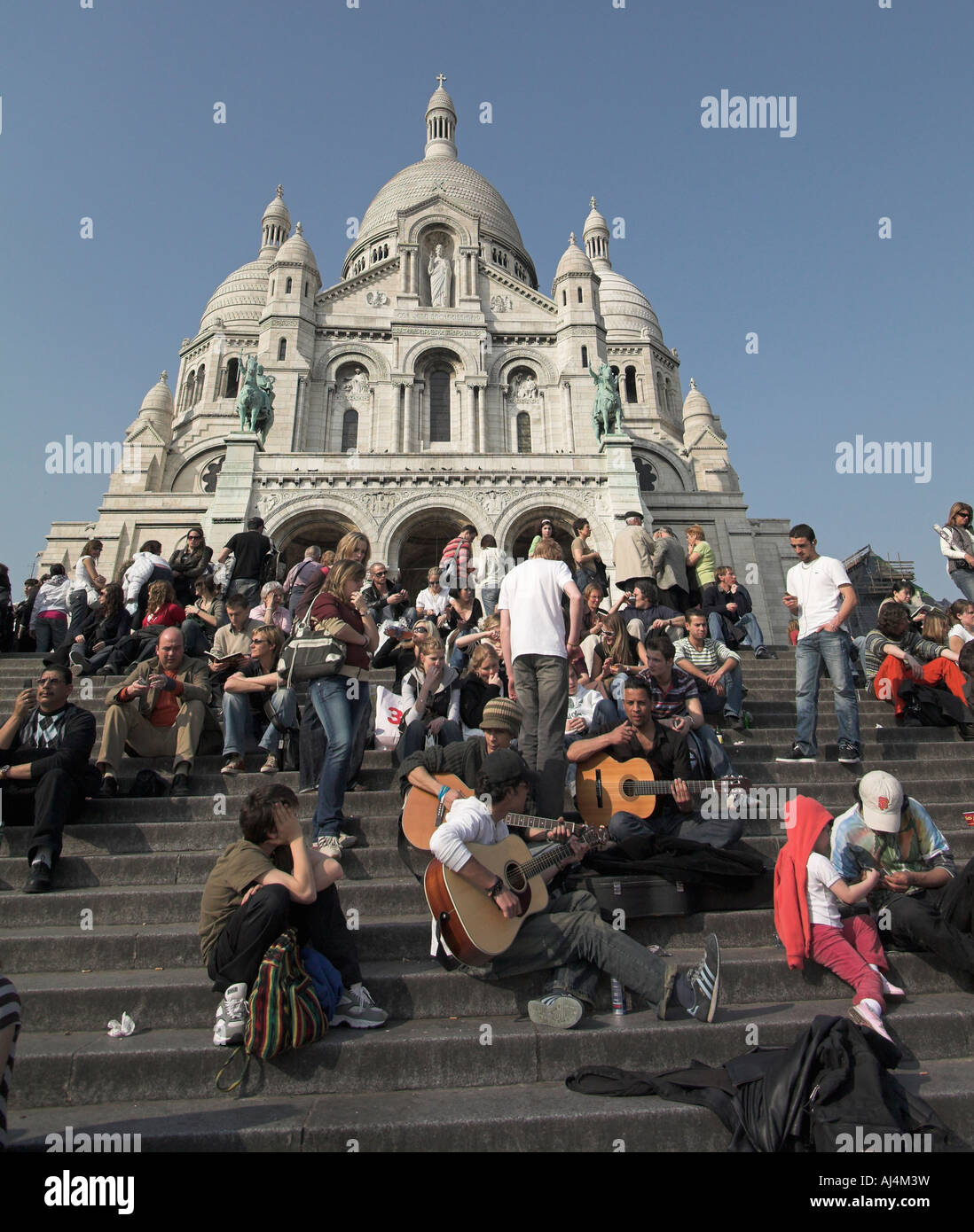 Sacre Coeur Montmartre Paris France tourists sitting on steps Stock ...