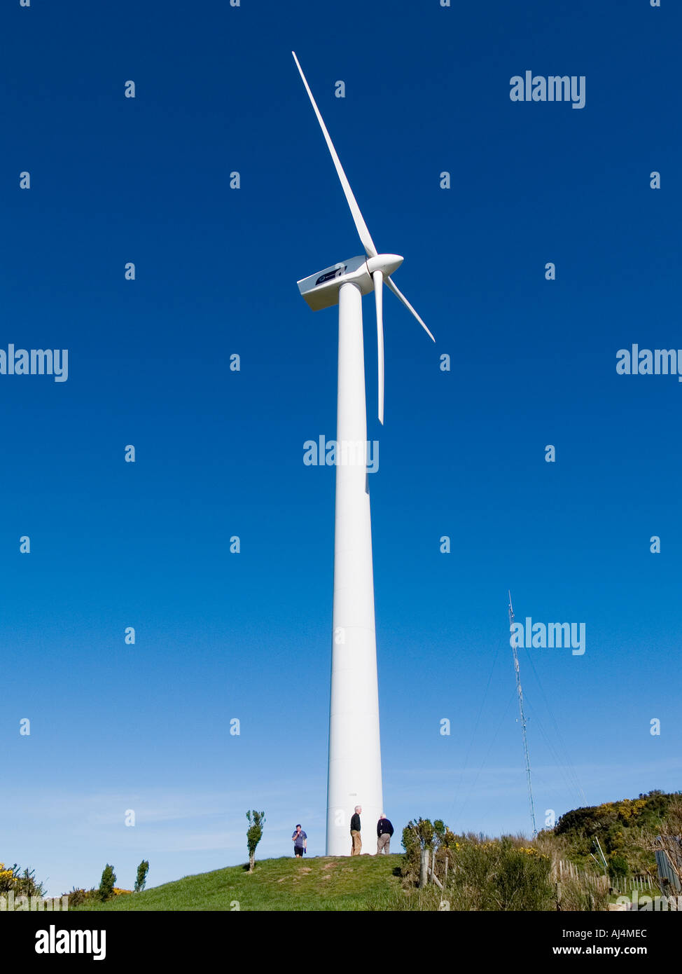 Sustainable energy wind turbine with people underneath Stock Photo - Alamy