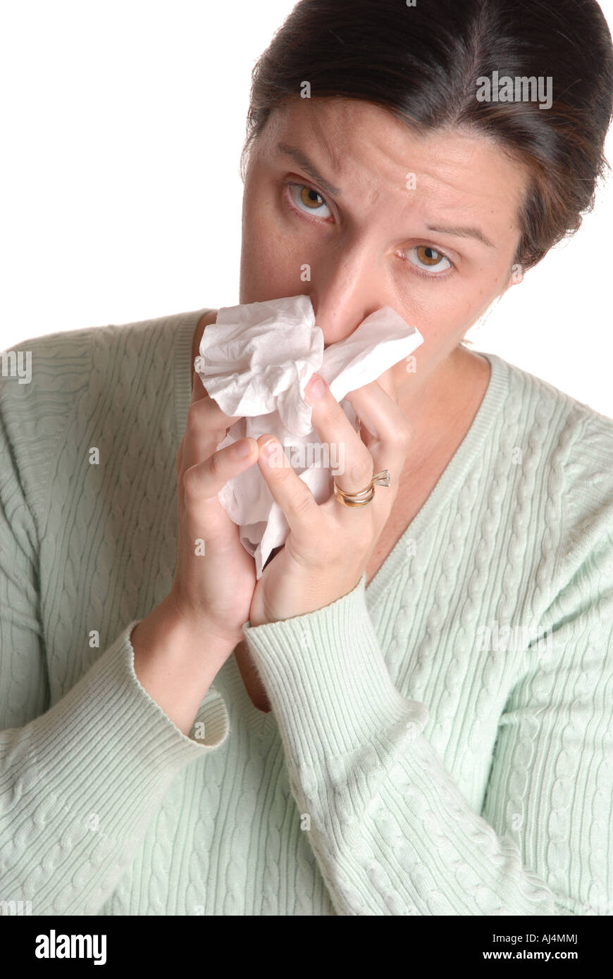 woman sneezing into tissue Stock Photo - Alamy