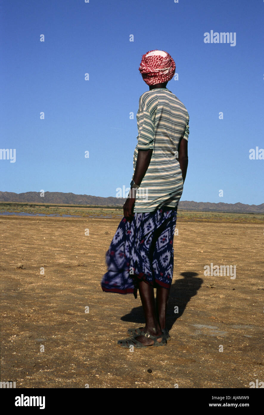 An Afar tribesman looks out across the barren landscape of Dankalia ...