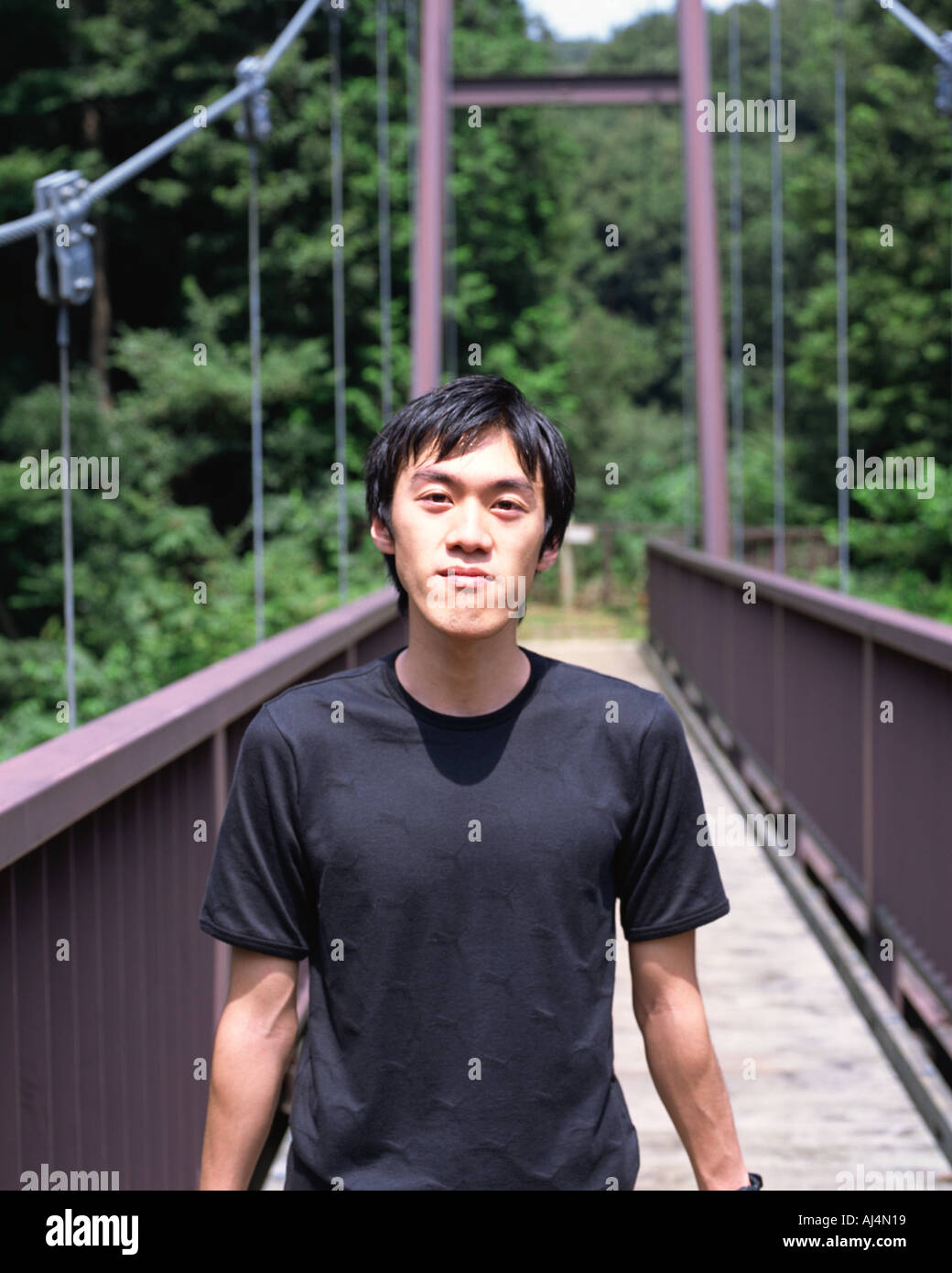 Young man standing bridge hi-res stock photography and images - Alamy
