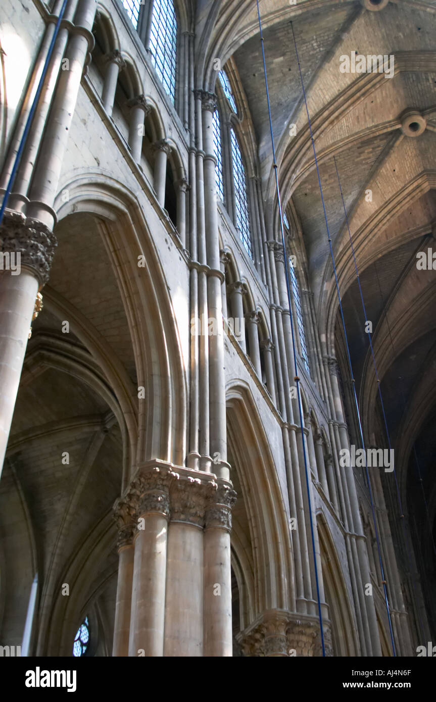 The Reims cathedral with its high gothic arched vaults and sun shining ...