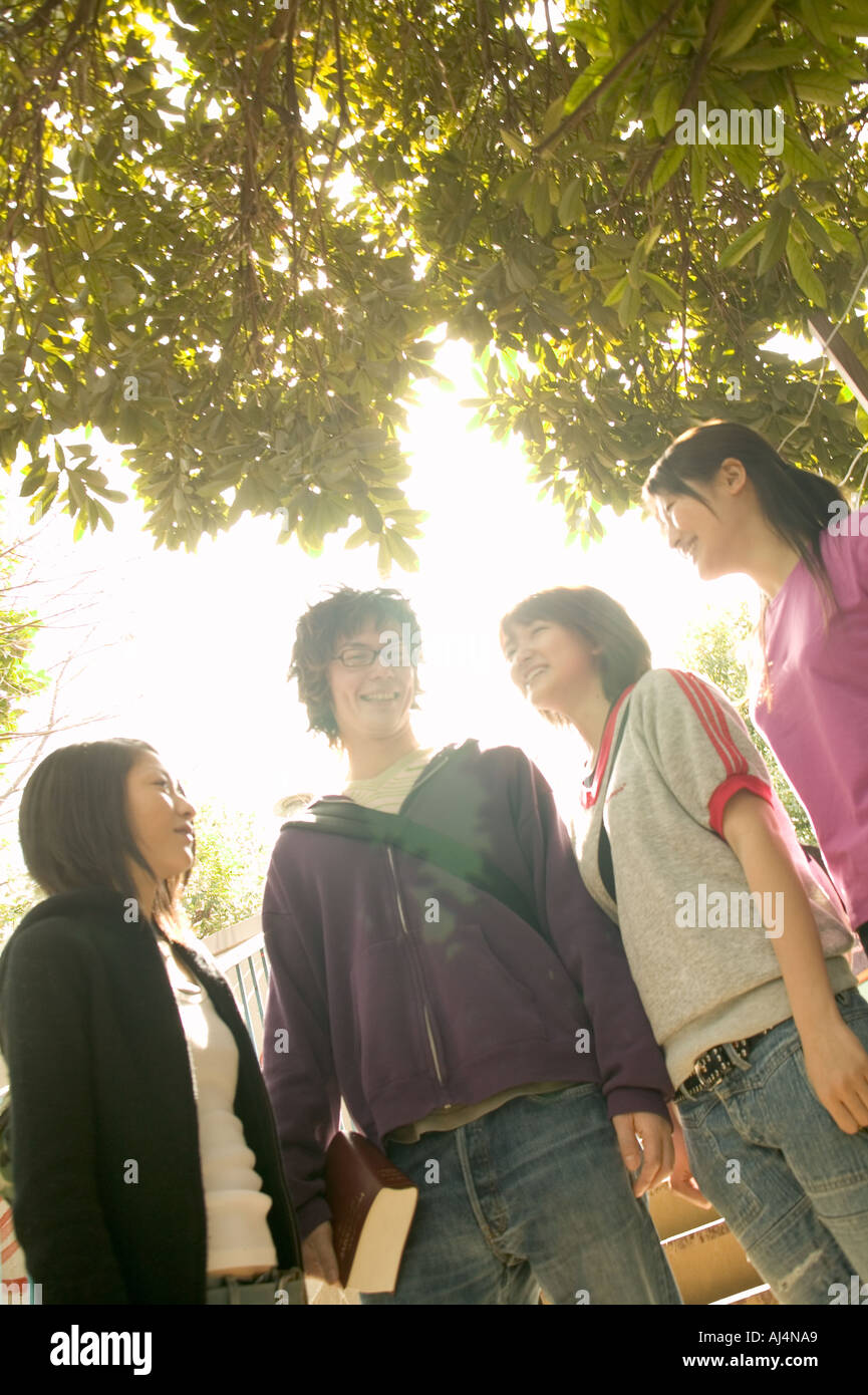 Four college students talking Stock Photo - Alamy